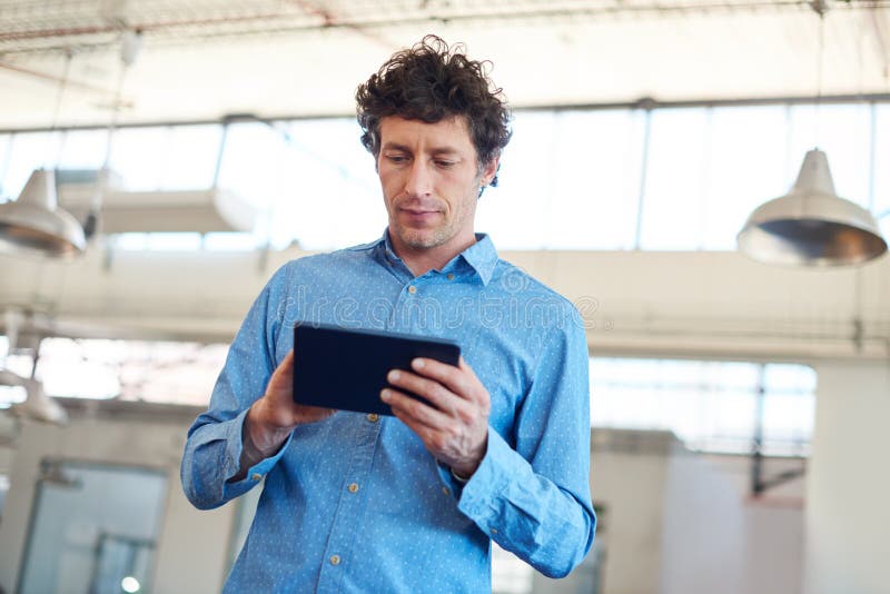 Working on His New Work Tool. a Handsome Businessman Working in the ...