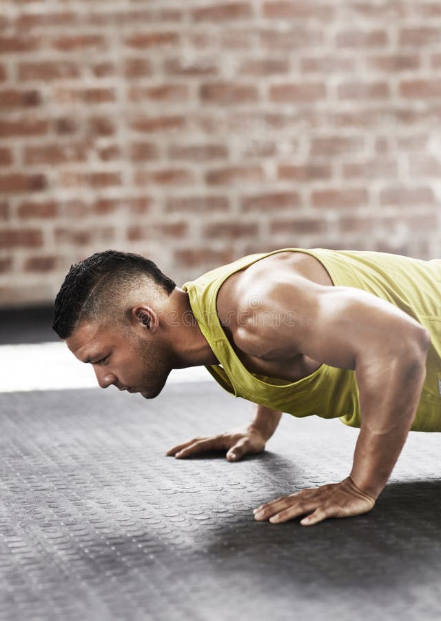 Working His Upper Body. a Young Man Working Out in the Gym. Stock Photo ...