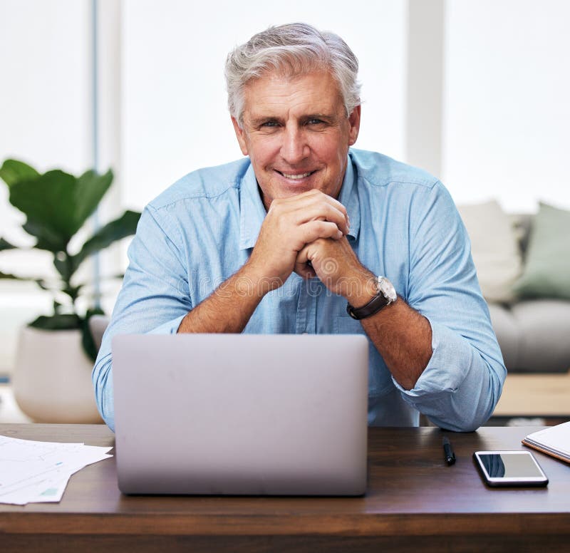 Working from Home Saves the the Back and Forth Commute. a Senior Man Sitting at Home with His ...