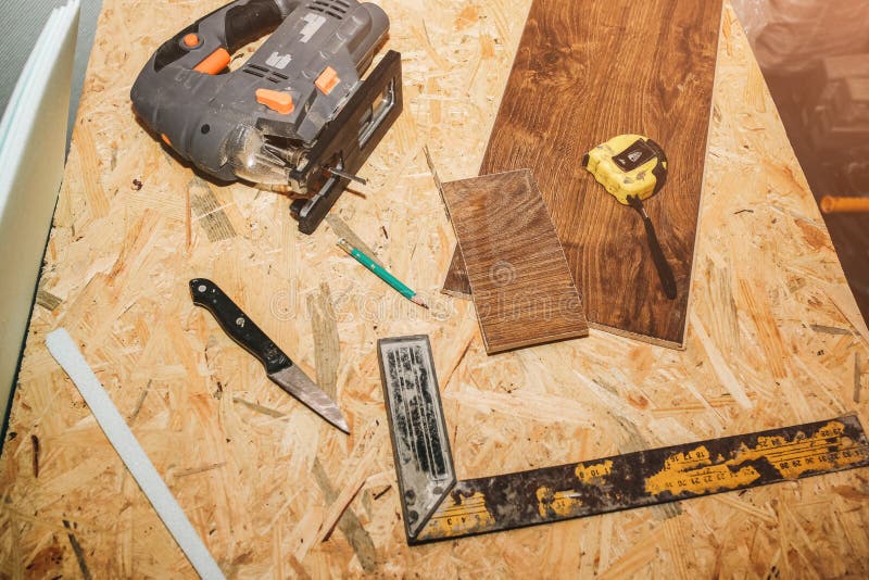 Working Instruments Lying on OSB Background. Power Jigsaw, Scroll Saw ...