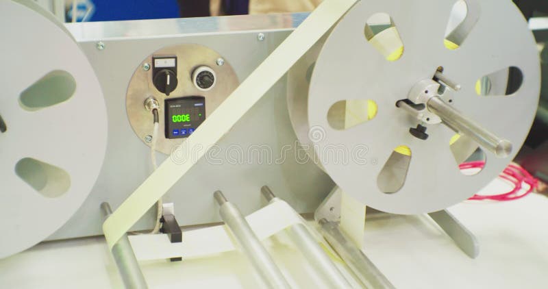 Working Labeling Machine from the Reel of Which the Tape with Labels is ...