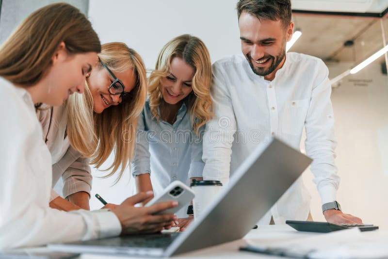 Working by Laptop Together. Group of Professional Business People is in ...