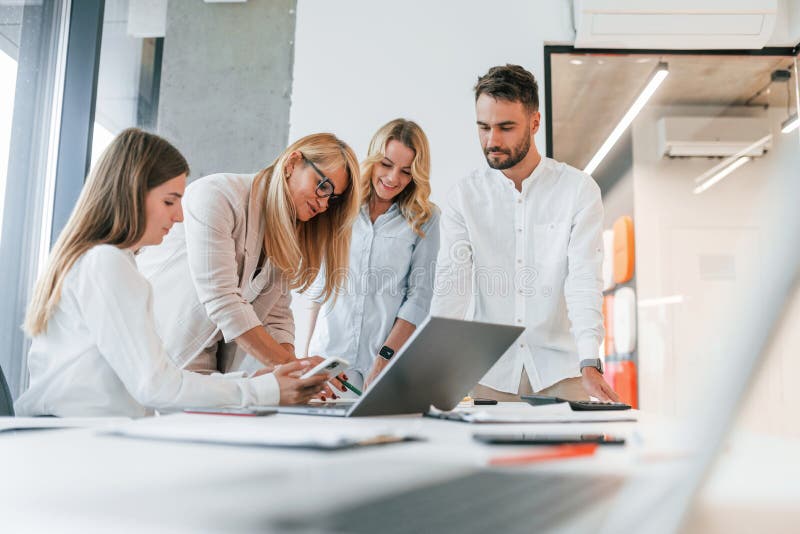 Working by Laptop Together. Group of Professional Business People is in ...