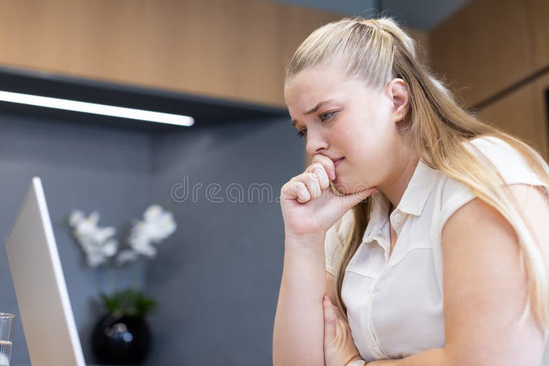 Working on Laptop, Woman Looking Concerned and Thinking in Office ...