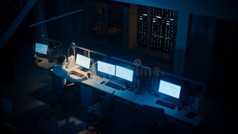 Working Late at Night in the Office: Businessman Using Desktop Computer ...