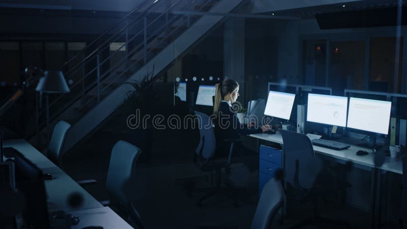 Working Late at Night in the Office: Businesswoman Using Desktop ...