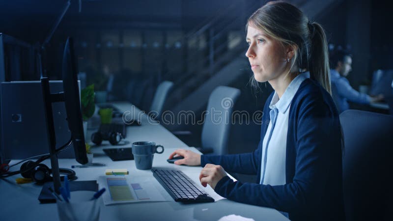 Working Late at Night in the Office: Businesswoman Using Desktop ...