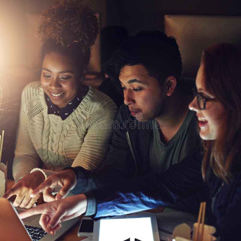Working Late Today Pays Off Tomorrow. a Business Team Using a Laptop ...