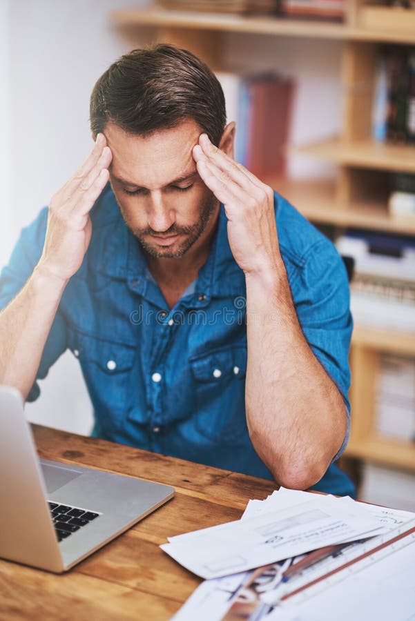Working a Little Too Hard. a Businessman Looking Stressed while Working ...