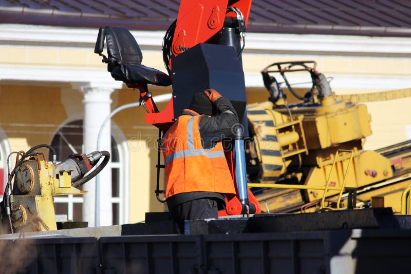 The Working Man Directs the Loader on the Railway during the Unloading ...