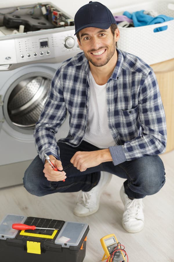 Working Man Fixing Washing Machine in Laundry Stock Image - Image of ...
