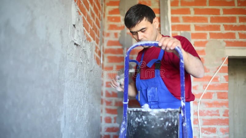Working Man on Ladder Making Plaster for Red Brick Stock Video - Video ...