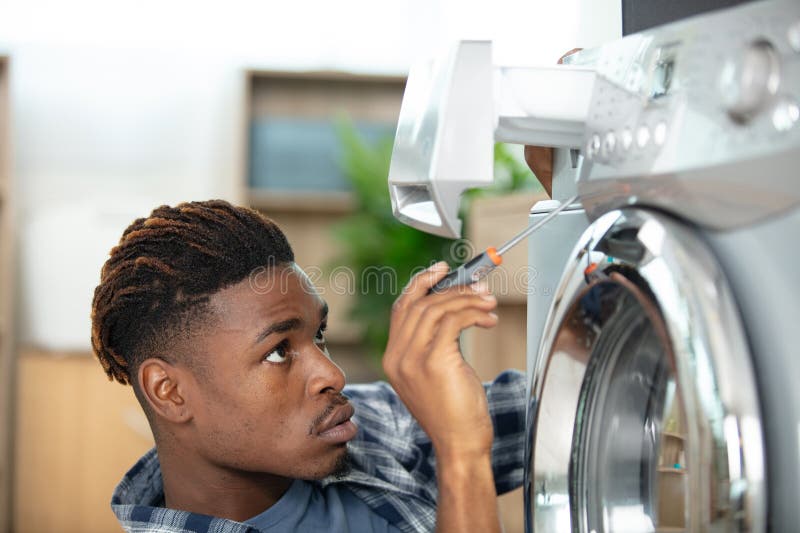Working Man Plumber Repairs Washing Machine in Laundry Stock Image ...