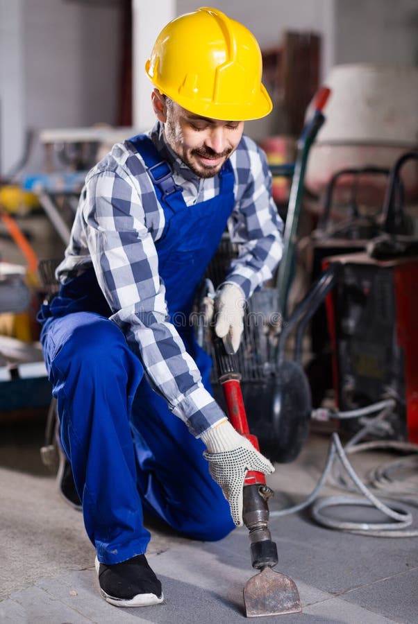 Working Man Practicing His Skills with Pneumatic Drill at Workshop ...