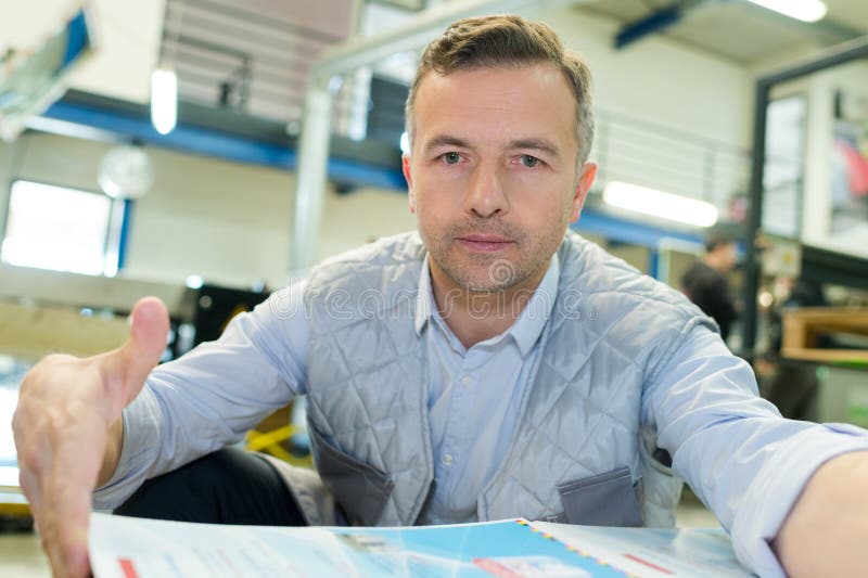 Working Man Tidying Papers in Industrial Premises Stock Image - Image ...