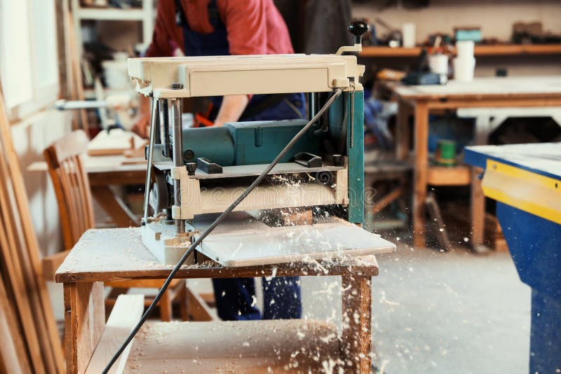 Working Man Using Thickness Planer at Carpentry Shop Stock Photo ...