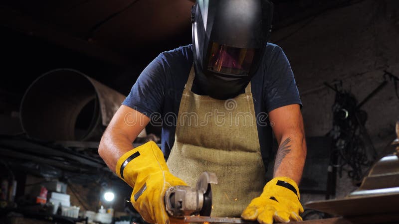 Working with Metal in the Workshop. a Man Wearing a Welding Mask To ...
