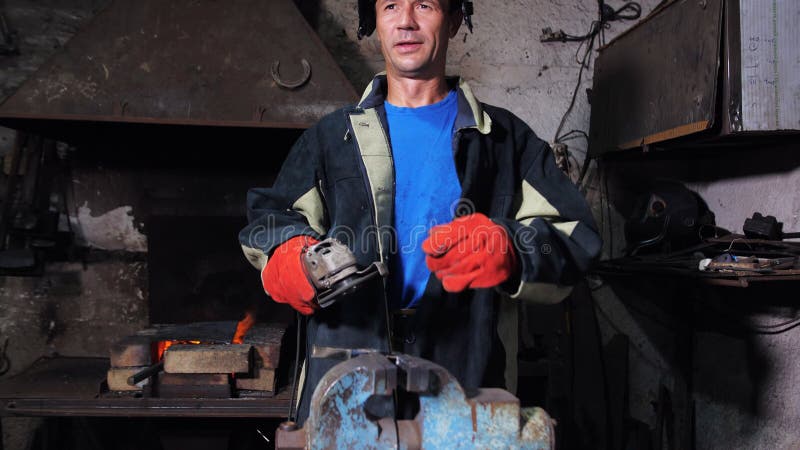Working with Metal in the Workshop. a Man Wearing a Welding Mask To ...