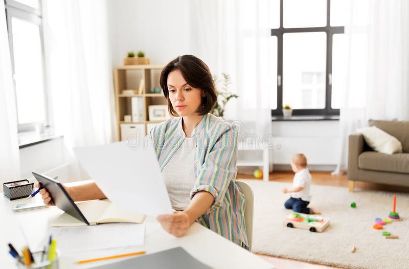 Working Mother with Tablet Pc and Papers at Home Stock Image - Image of freelancer, multitasking ...