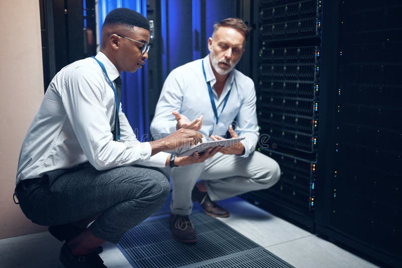 Working through Multiple Issues at a Time. Two Technicians Using a ...