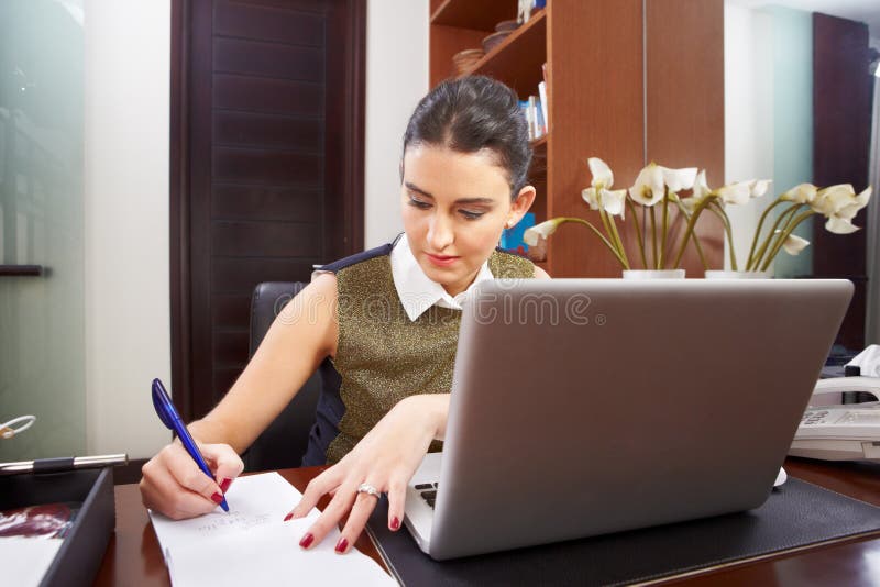 Working in office. Hispanic, writing. - Stock Image - Everypixel