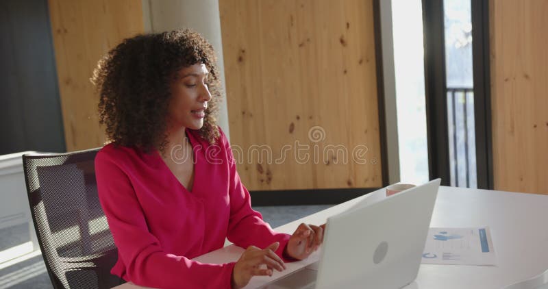Working in Office, Woman Using Laptop and Reaching for Documents on ...