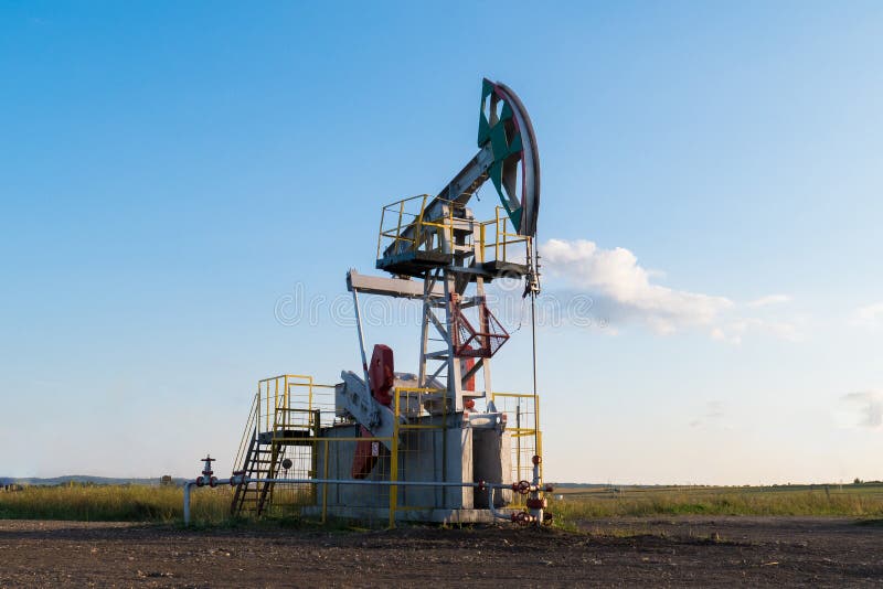 Working Oil Pump on the Ground among the Green Fields Stock Photo ...
