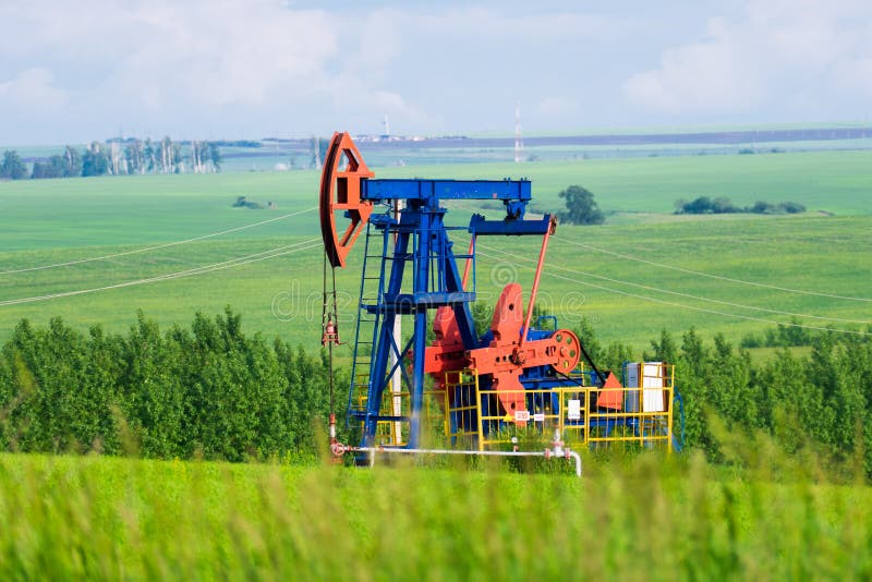 Working Oil Pump on the Ground among the Green Fields Stock Image ...