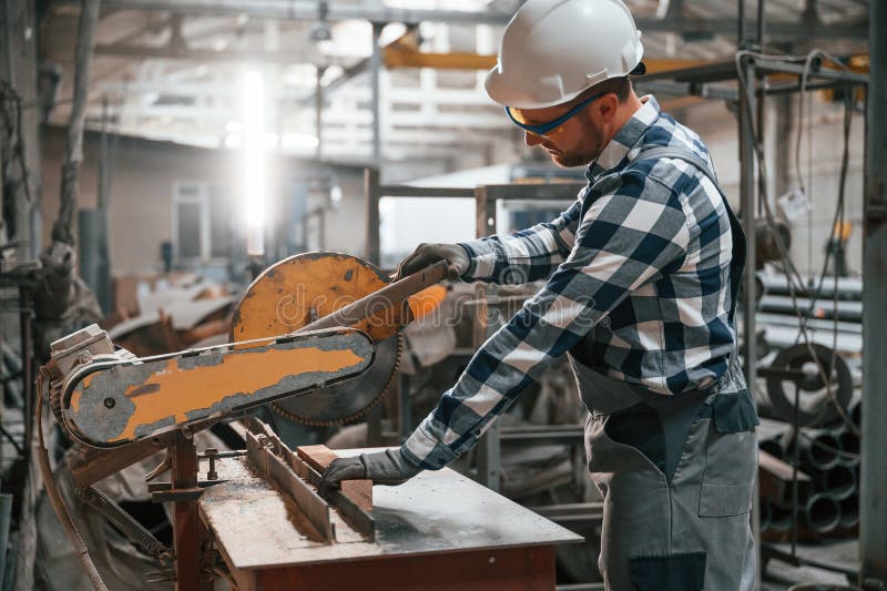Working by Operating Machine. Factory Worker in Uniform is Indoors ...