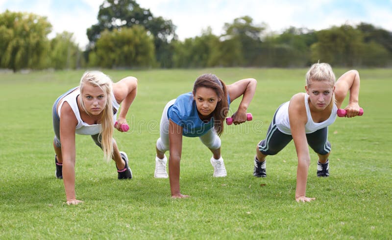 Working Out As a Team. a Group of Young Women Working Out with ...