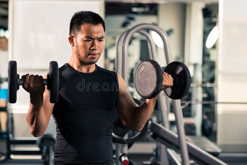 Working out with dumbbells stock photo. Image of handsome - 58053764