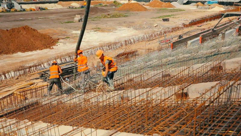 Working Process at a Construction Site. Workers Make a Reinforced ...