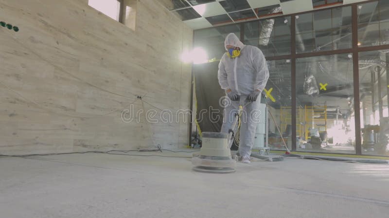 Grinding a Concrete Floor with a Grinder. Builder Works Concrete Floor ...