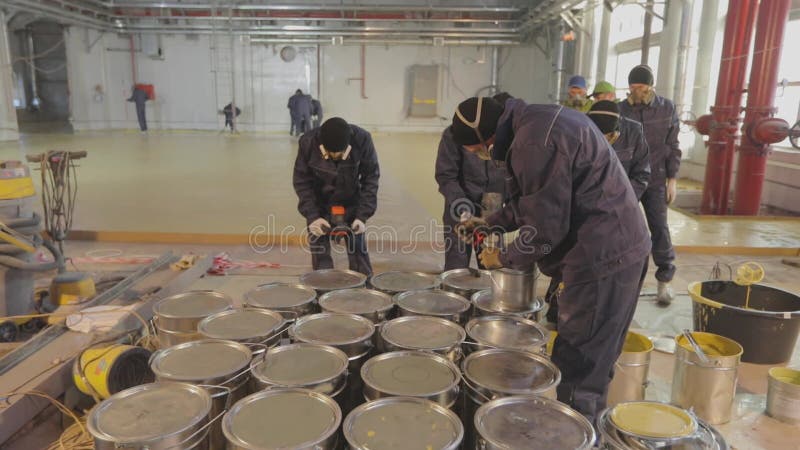 Working Process at a Construction Site. Workers Stir Up the Bulk Floor ...