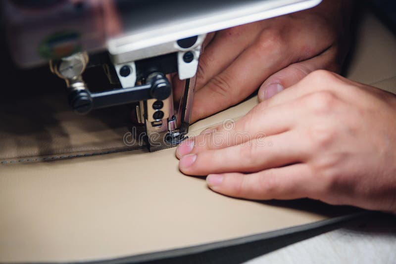 Worker Sewing Leather Product on the Sewing Machine. Leather Worker ...