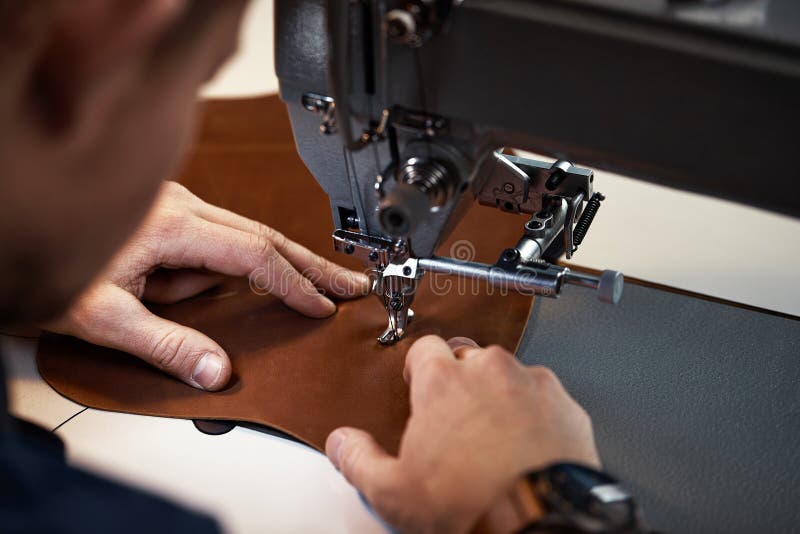 Working Process of Leather Craftsman. Tanner or Skinner Sews Leather on ...