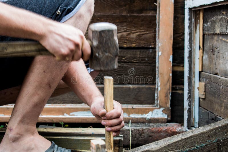 Working Process. Men`s Hands at Work. Clogging the Boards. Tools - a ...