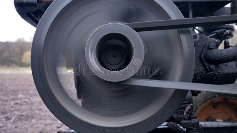 Working Process of Rotating Pulley with Belt. Man Works in Garden with ...