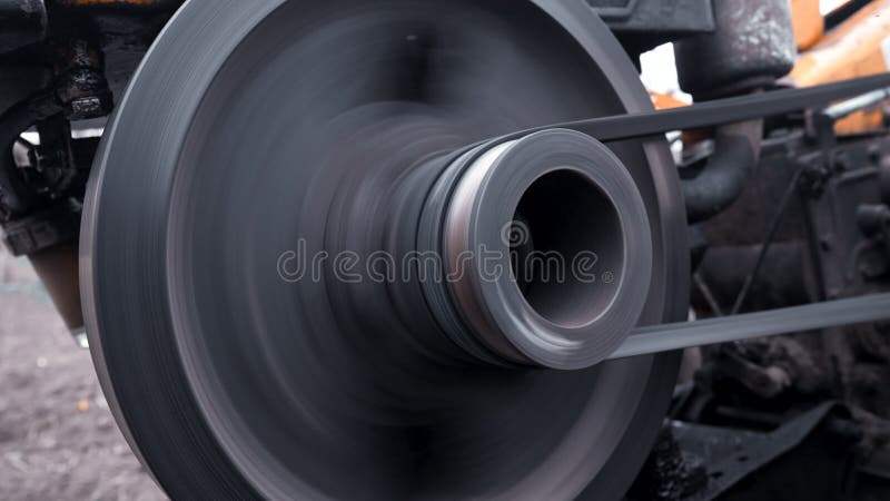 Working Process of Rotating Pulley with Belt. Man Works in Garden with ...