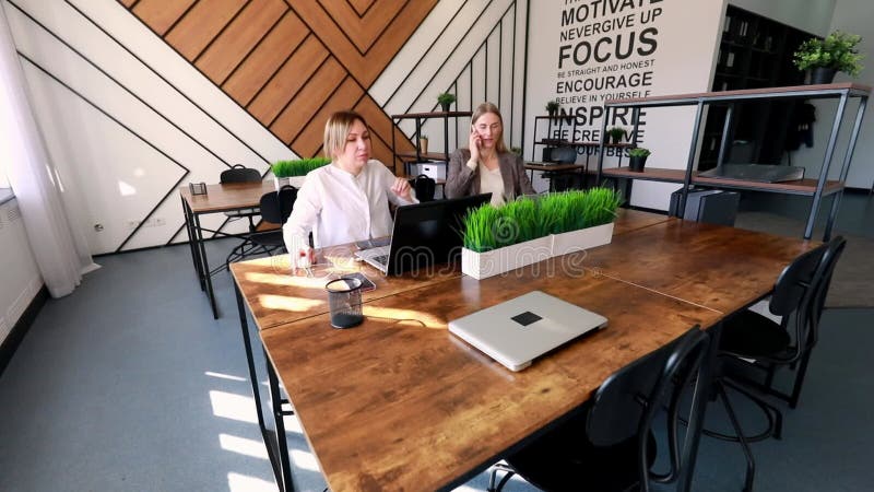 Working Professionals Collaborate in a Stylish Office Space with Modern ...