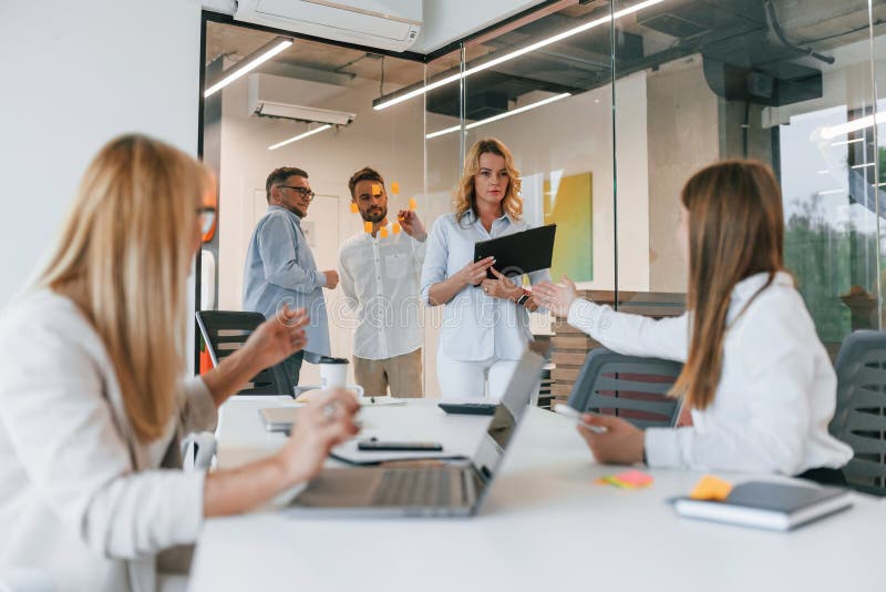 Working with Project. Group of Professional Business People is in the ...