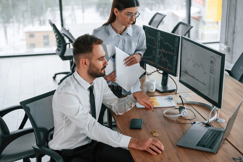 Working on a Project Together. Two Employees are in the Office Stock ...