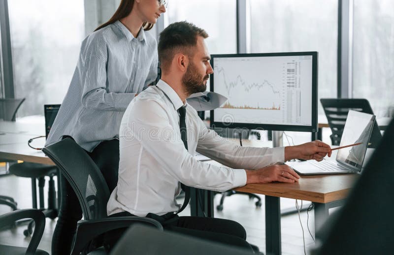 Working on a Project Together. Two Employees are in the Office Stock ...