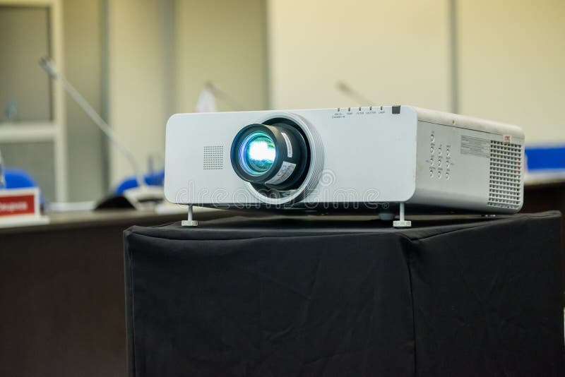 Working Projector at the Conference Hall. Blurred People at Background ...