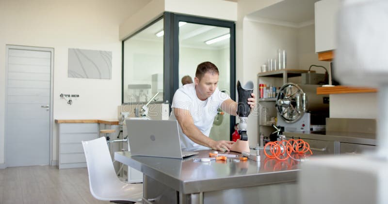 Working in Prosthetic Lab, Man Adjusting Prosthetic Limb with Tools on ...