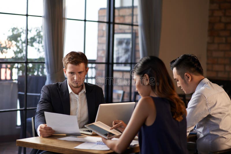 Working on report together stock image. Image of document - 103050911