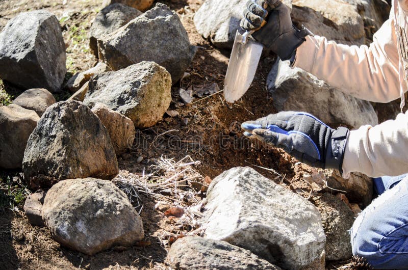 Working on a rock wall stock photo. Image of mortar - 111657528