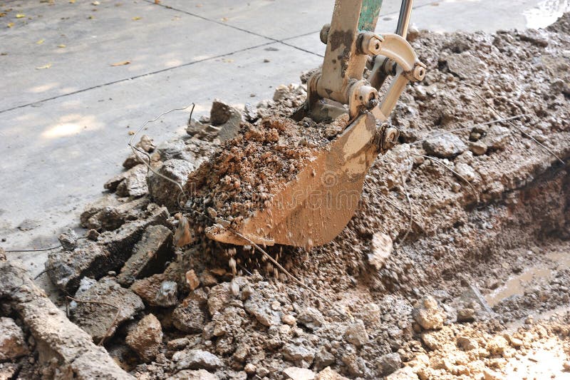 Scoop of Excavator is Digging Hole. Excavator Digs Pit in Ground for ...