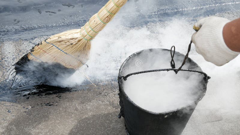 Working Seals Cracks on the Roof with Help of Melted Tar. Roof Repair ...