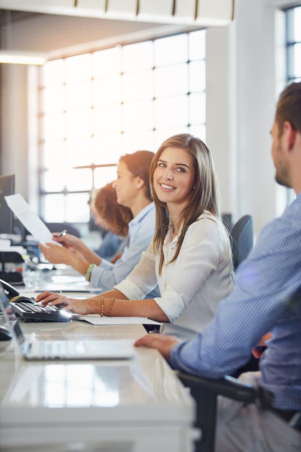 Working with a Smile. a Group of Businesspeople Working in the Office ...